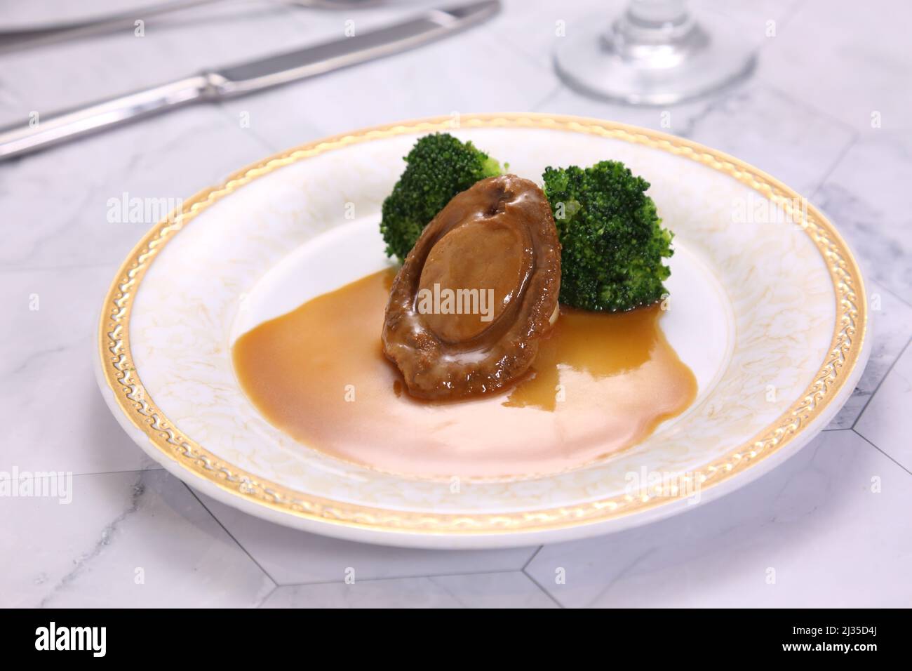 head premium abalone in a dish isolated on grey background side view of ...