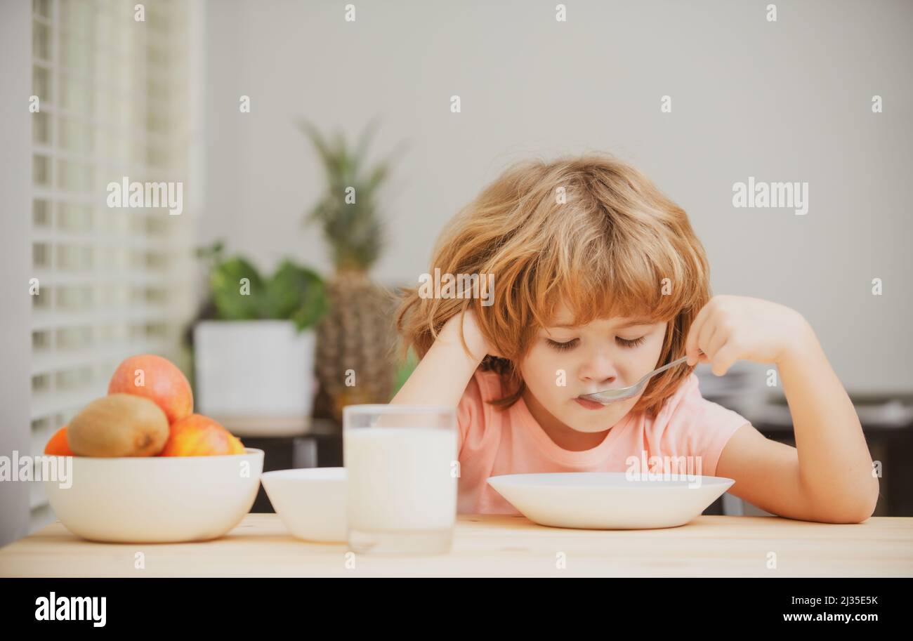 Portrait of child eating soup meal or breakfast having lunch by the ...
