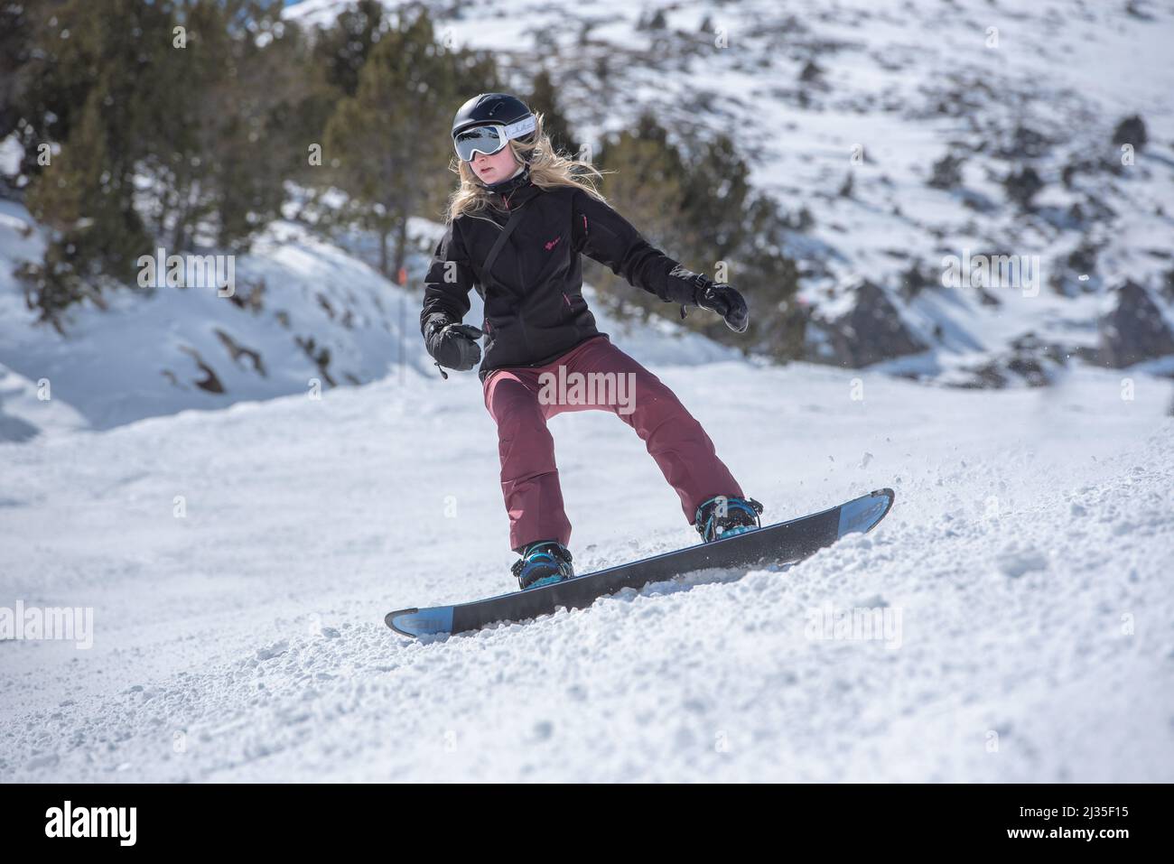 Grandvalira, Andorra: 2022 January 25: Young woman on snowboard in the ...