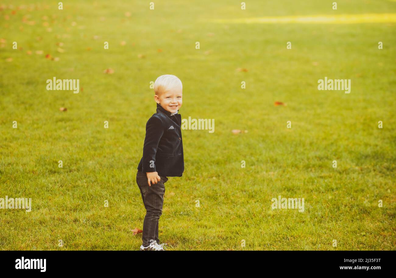 Spring kid on meadow field. Happy childhood. Child boy sunny portrait ...
