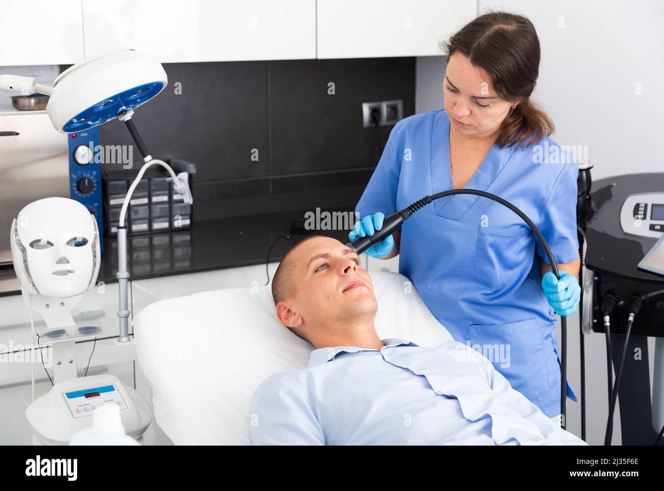 Man getting face ultrasound lifting procedure Stock Photo - Alamy