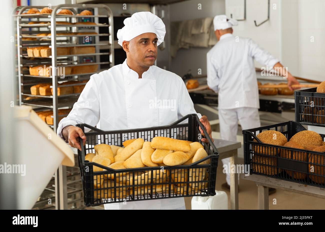 male baker with sesame bread in black box in kitchen Stock Photo - Alamy