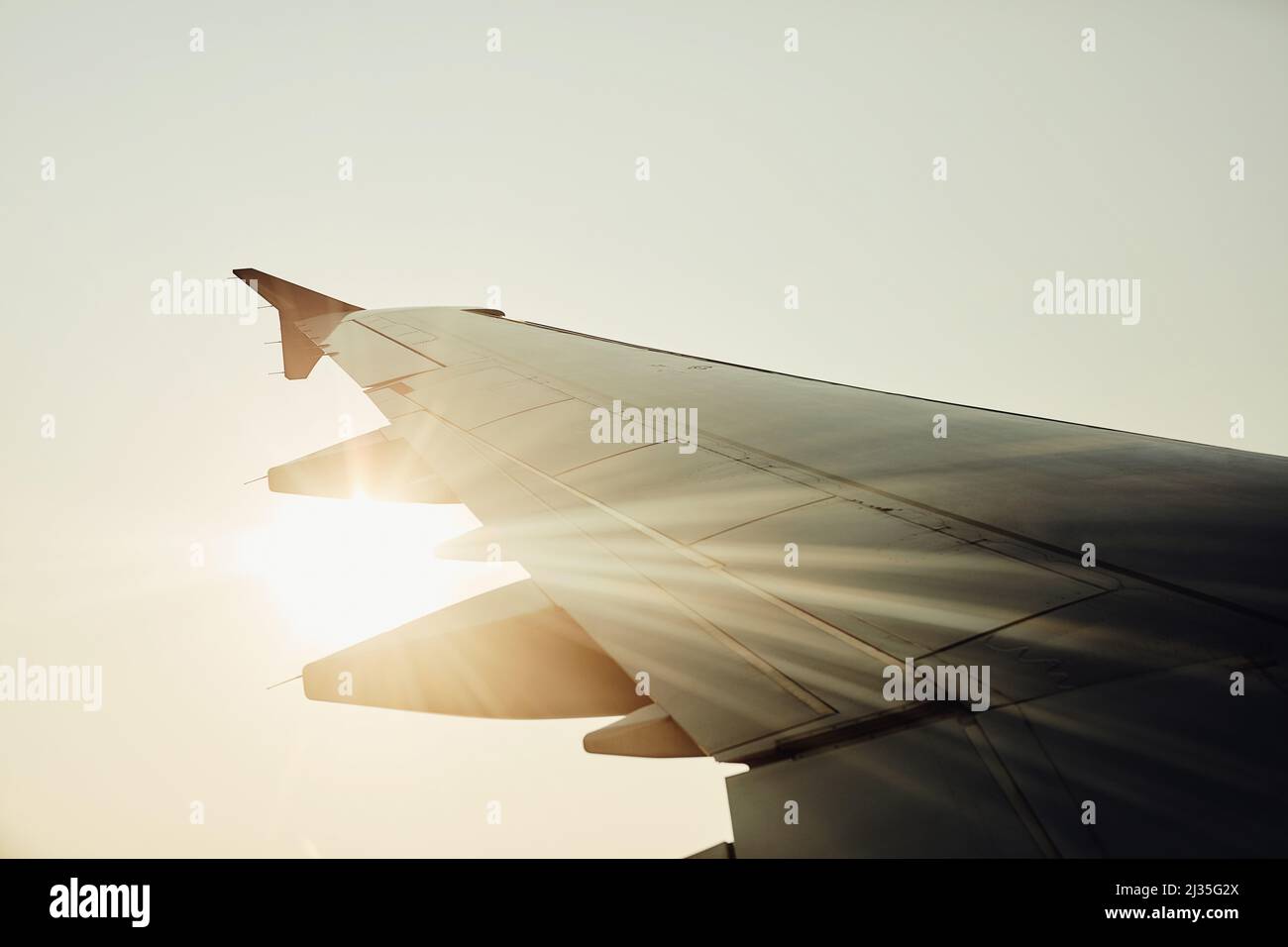 Lets fly away. Cropped shot of an airplanes wing in mid flight Stock ...