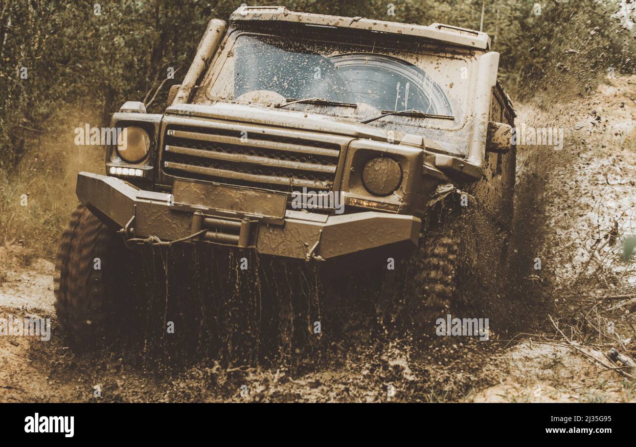 Mud and water splash in off-road racing. Offroad vehicle coming out of ...