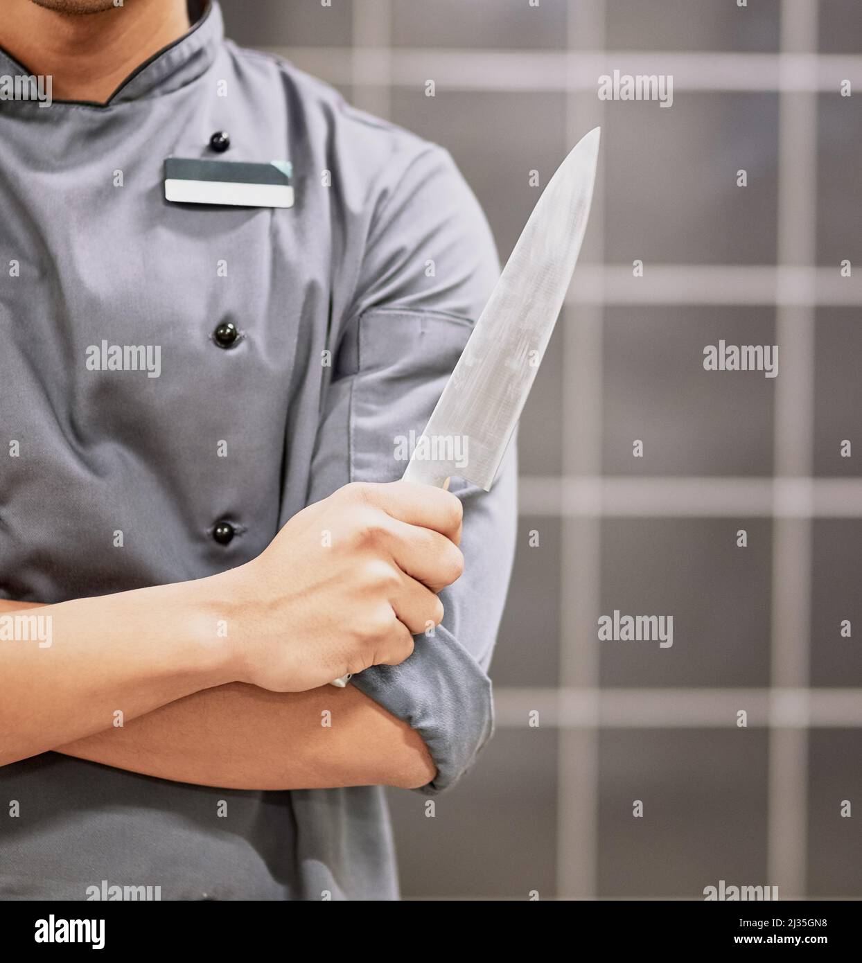 Making the cut in the kitchen. Cropped shot of an unrecognizable chef ...