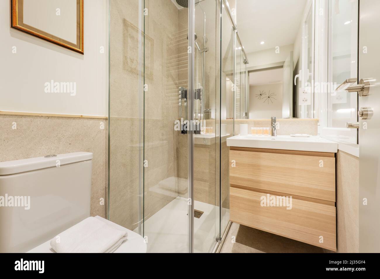 WC with walk-in shower with hanging wooden vanity unit and white ...