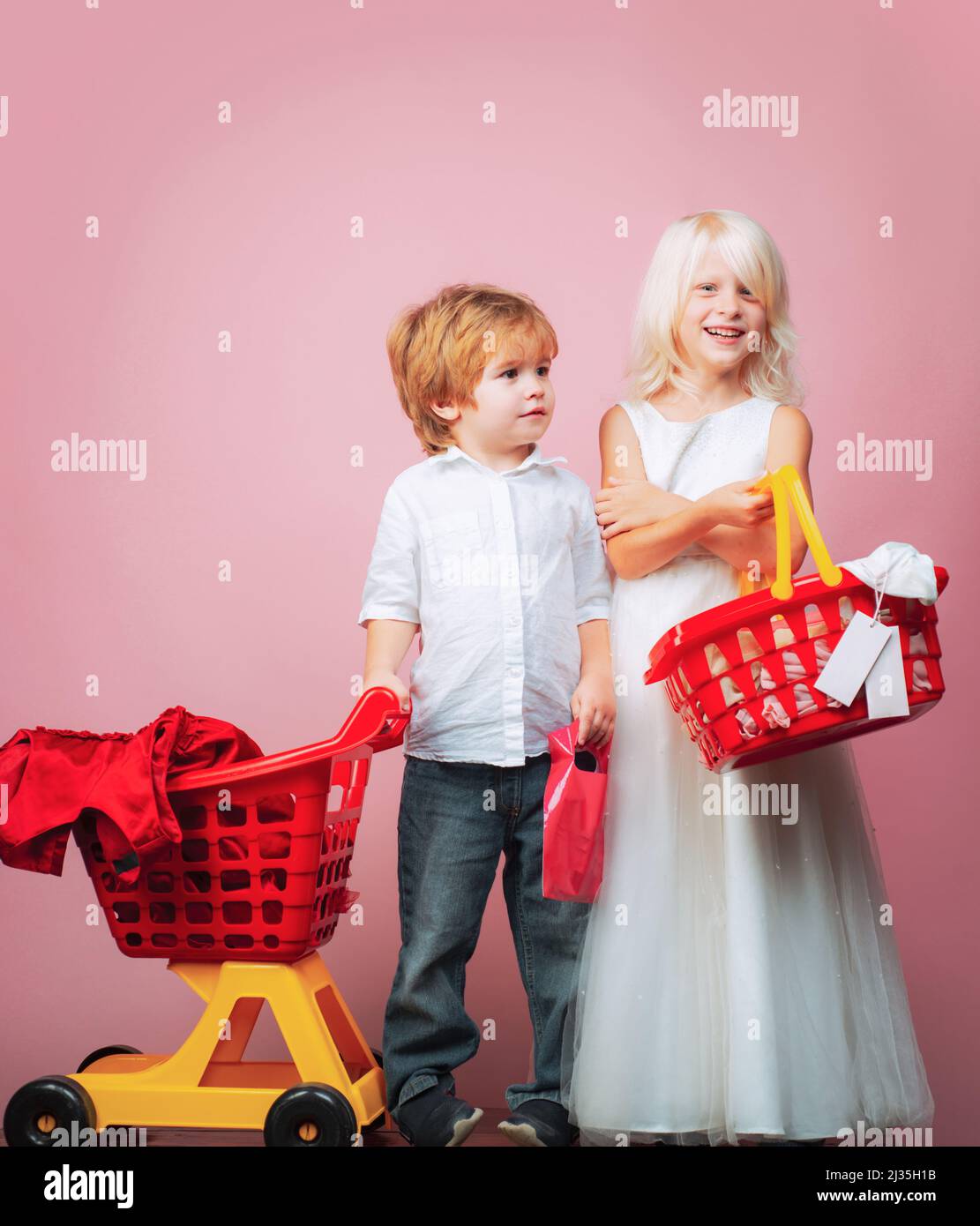 Girl and boy children shopping. Couple kids hold plastic shopping ...