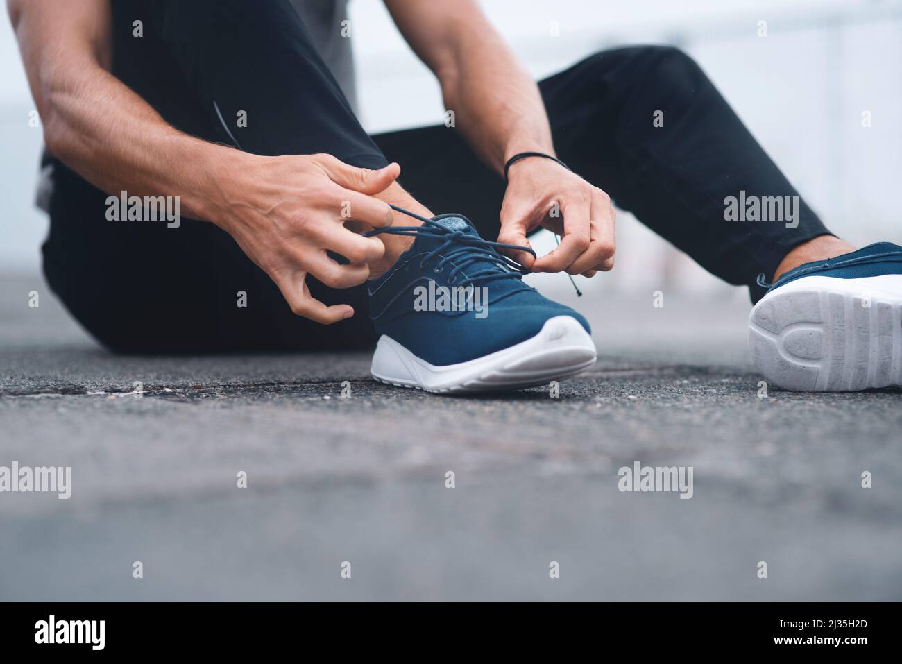 Tie them securely to avoid tripping. Closeup shot of an unrecognisable ...