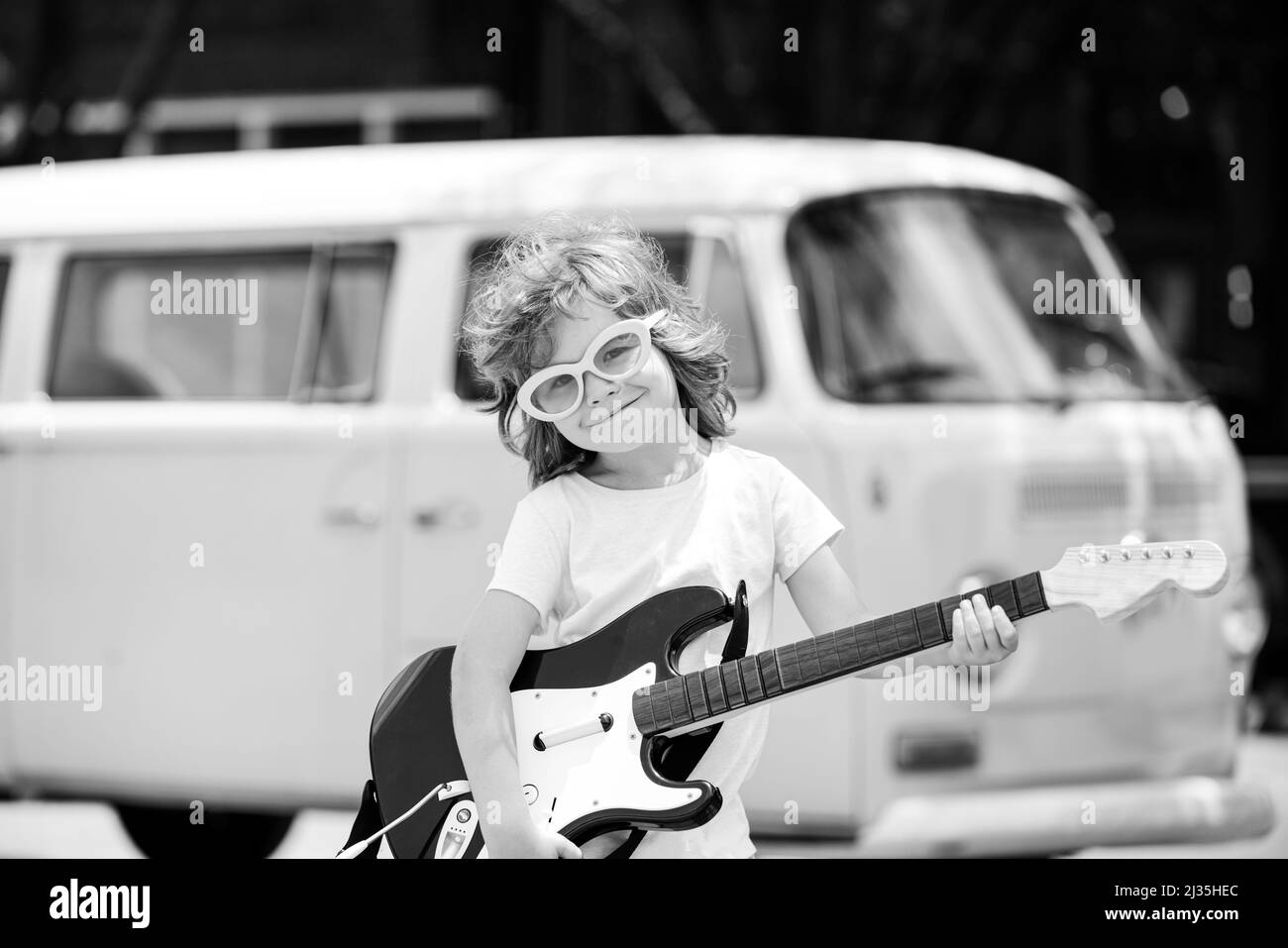 Happy child musician guitarist playing electric guitar Stock Photo - Alamy