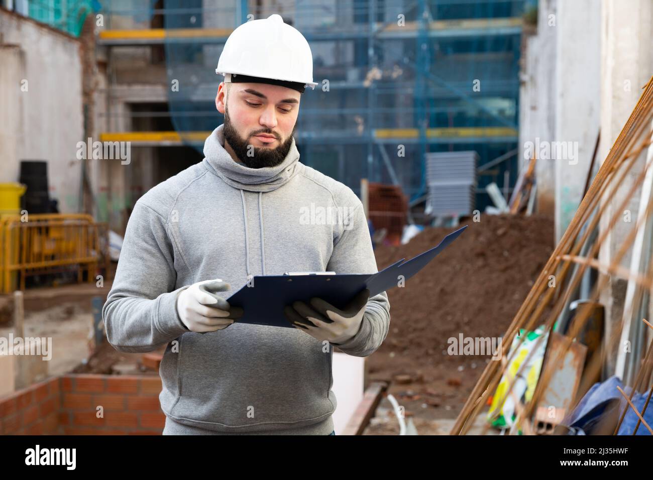 Engineer planning renovation works at building site Stock Photo - Alamy