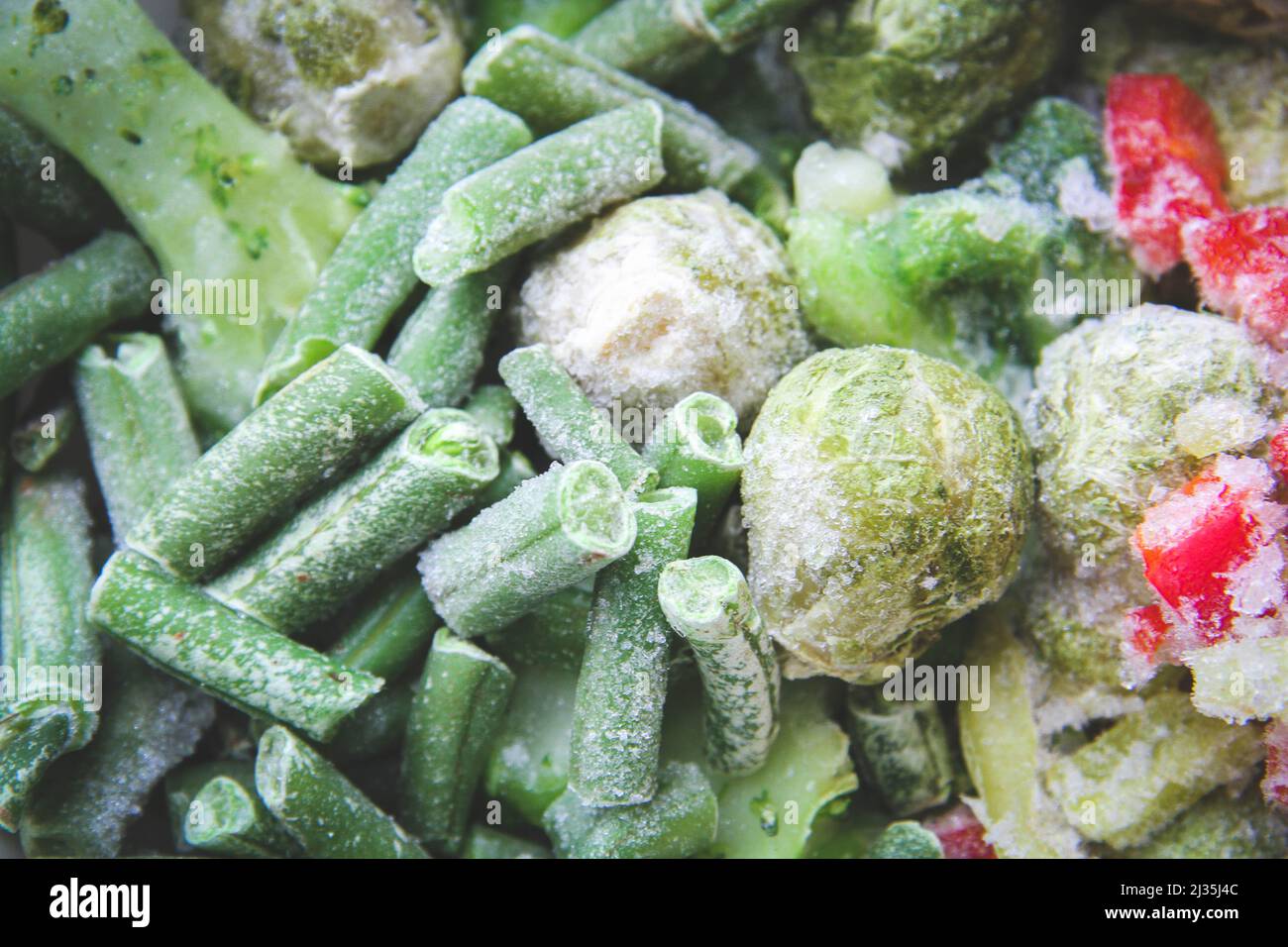 Frozen vegetables close up. Vegetables in the fridge. Ice on vegetables ...