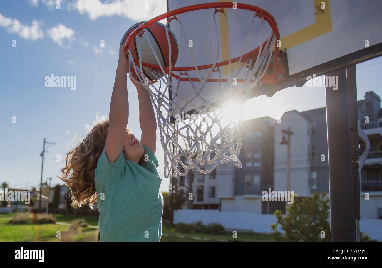 Kid boy basketball player with a ball scoring a goal. Child Player ... Kid boy basketball player with a ball scoring a goal. Child Player ...