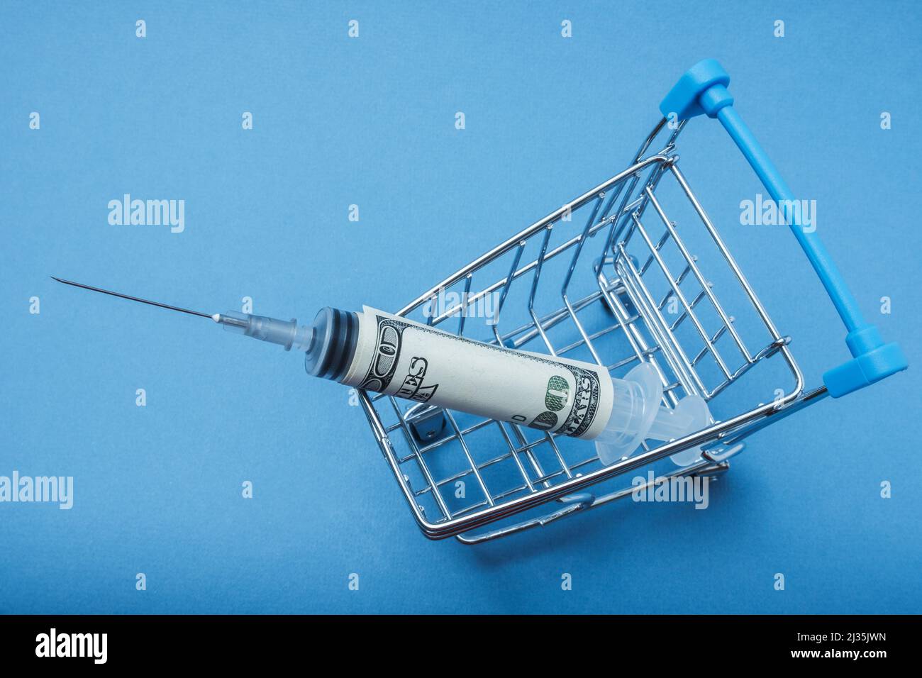 The syringe wrapped in a dollar is in the basket. Offering a financial ...