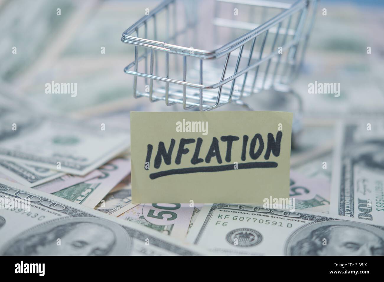 Shopping cart with inflation poster on a blurred background made of ...