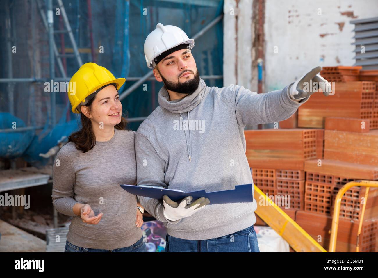 Engineers inspecting process of building overhaul Stock Photo - Alamy