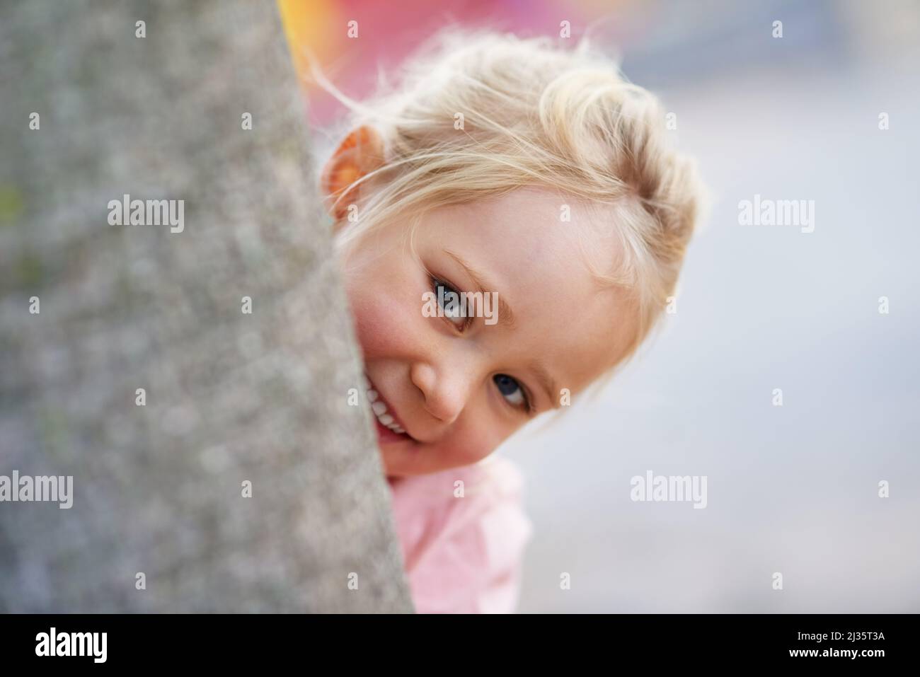 Shes got a mischievous look in her eyes. Portrait of a cute little girl ...