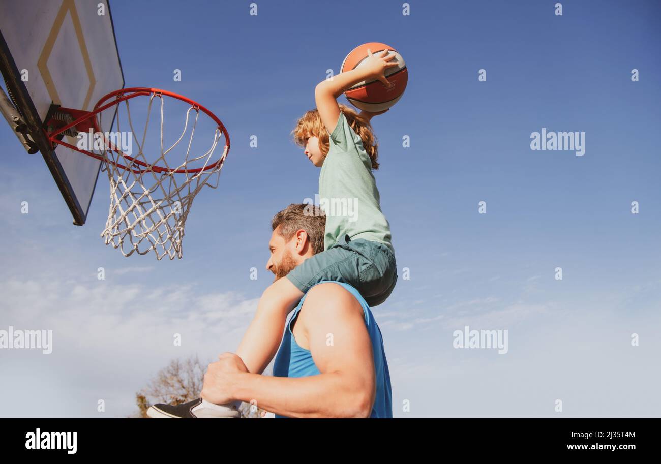 Father and son playing basketball. Happy father holding his little son ...