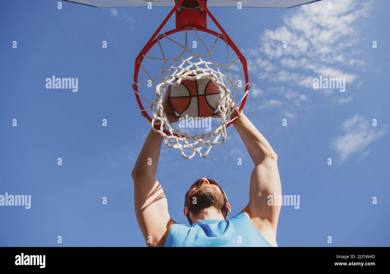 Close up image of professional basketball player making slam dunk ...