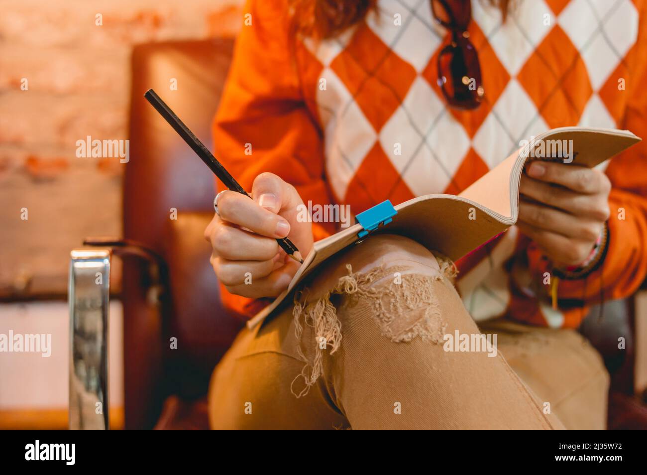 closeup unrecognizable caucasian woman writing notes with a pencil in ...