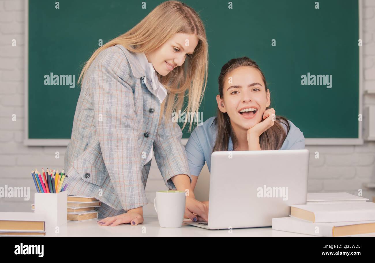 Students girls in classroom at college. Two students doing homework ...