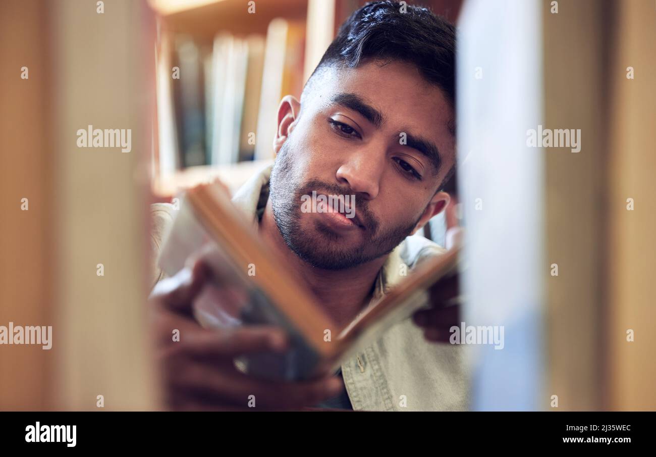 Man taking a book from shelf hi-res stock photography and images - Alamy