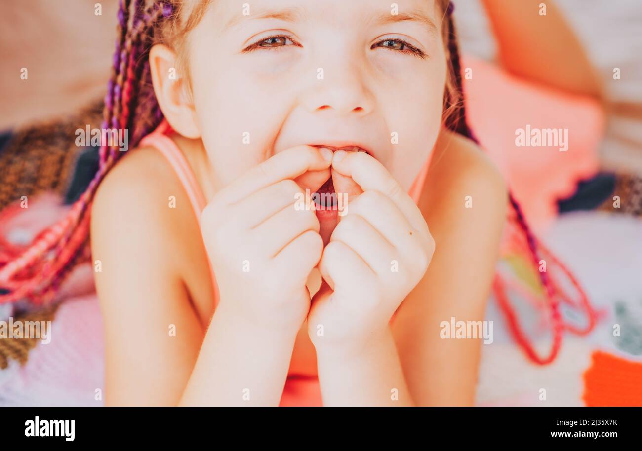 Kids teeth. Smiling girl holding missing tooth. Funny face close up ...