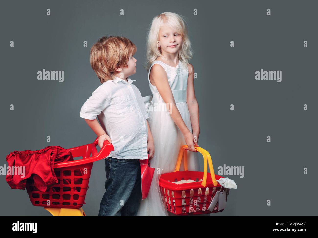 Cute buyer customer client hold shopping cart. Girl and boy children ...