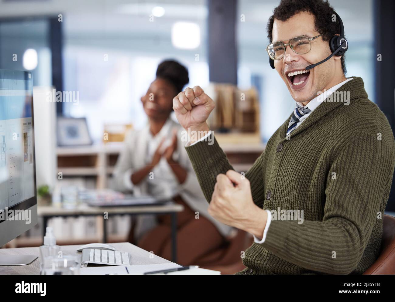 When one of us wins, we all win. Shot of a two colleagues celebrating ...