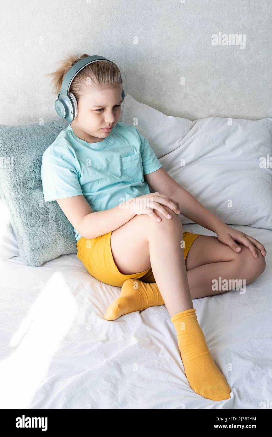 Child wearing headphones listens to music. Boy listening to music in ...