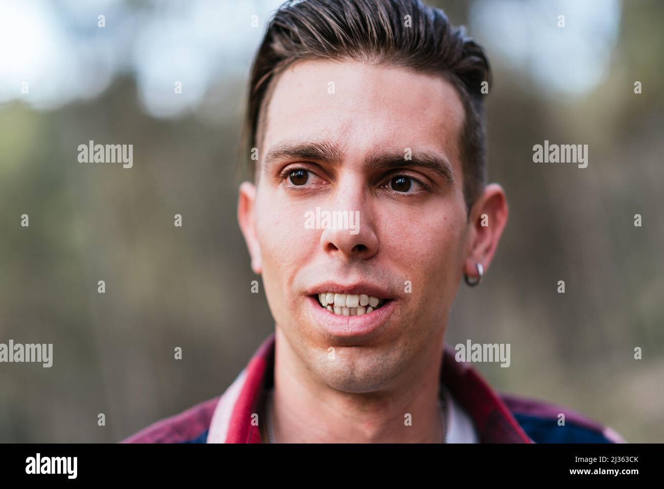 Adult male with stylish haircut and brown eyes wearing shirt looking ... Adult male with stylish haircut and brown eyes wearing shirt looking ...
