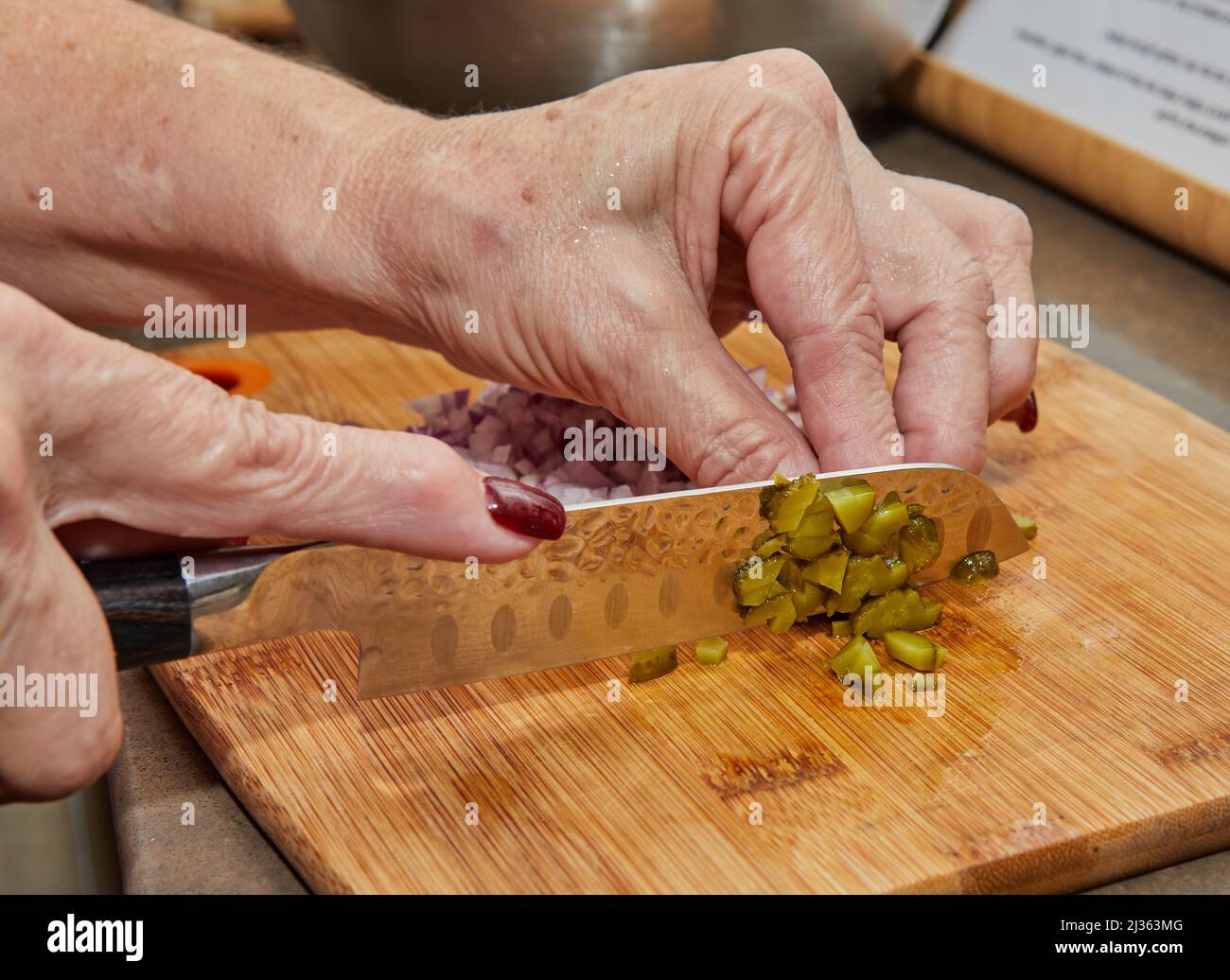 Hand knife cuts pickled cucumber hi-res stock photography and images ...