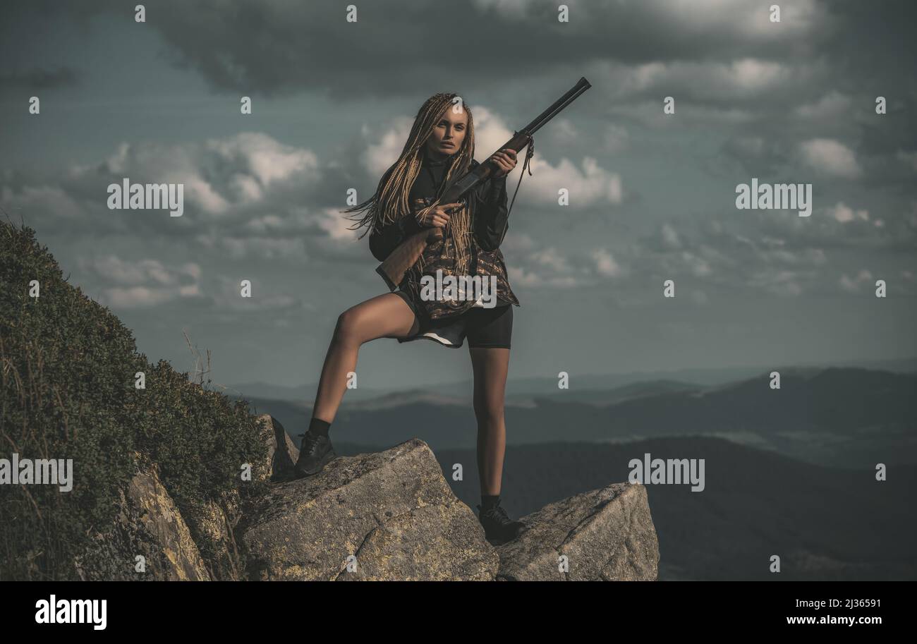 Hunter woman holding gun and walking in forest. Hunter Education Course ...