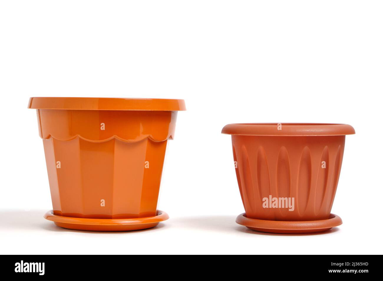 Two brown plastic empty flower pots white background Stock Photo - Alamy