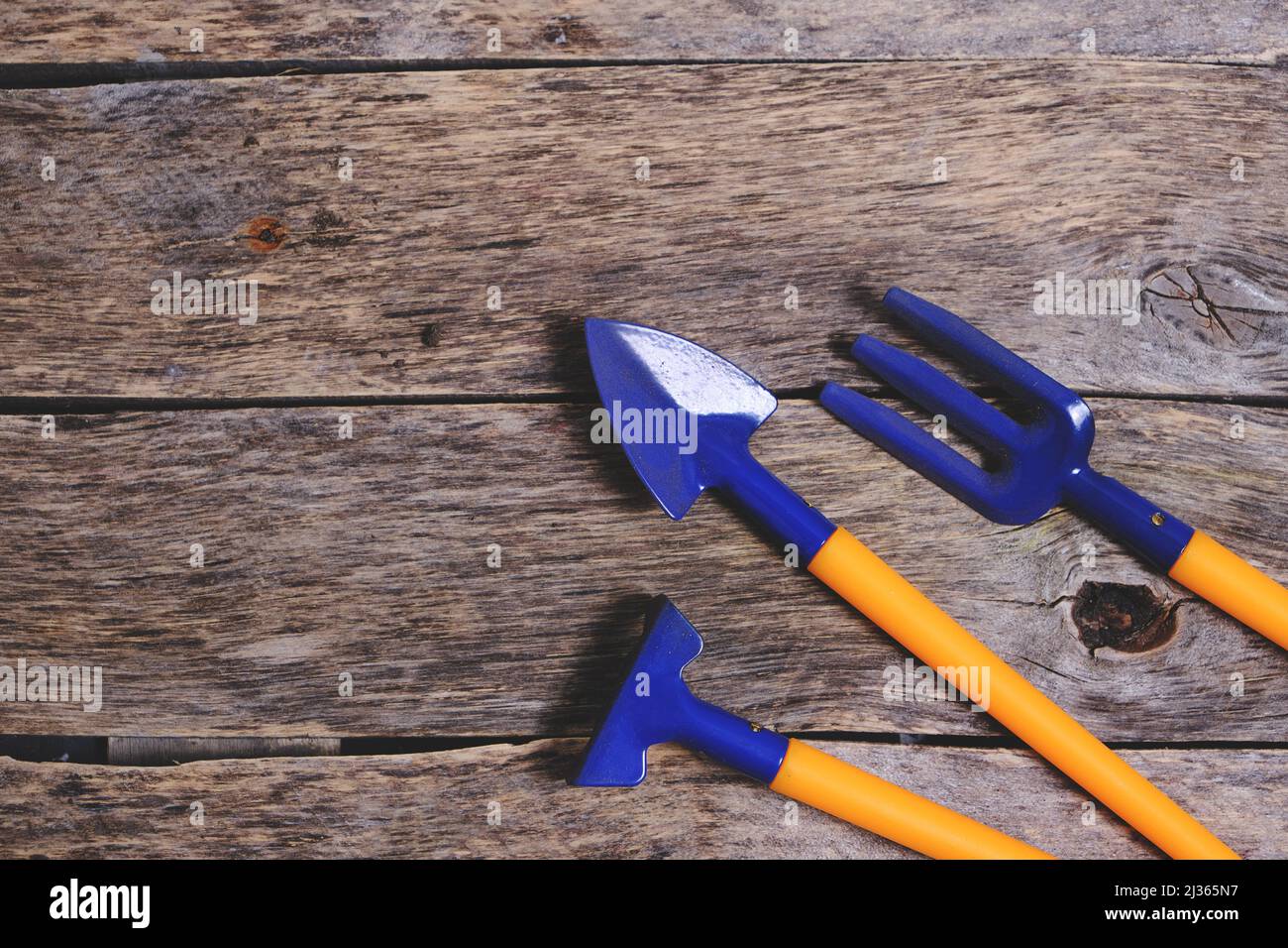 Decorative rake, pitchfork and shovel, garden tool wooden background ...