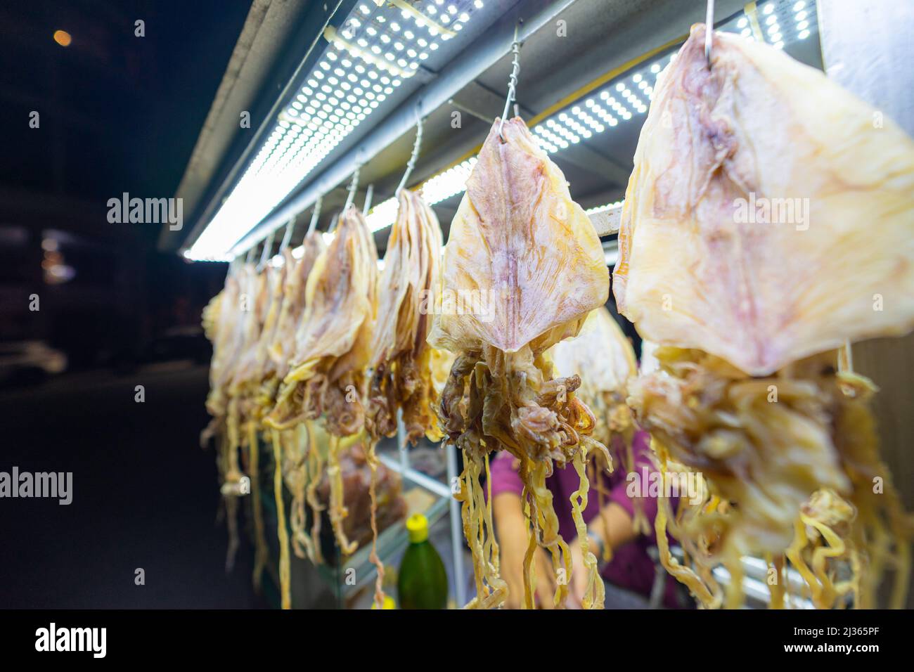 Traditional walking business selling dry squid on the street at night ...