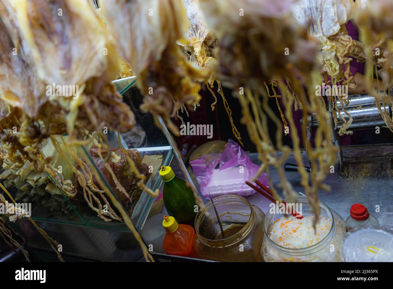 Traditional walking business selling dry squid on the street at night ...