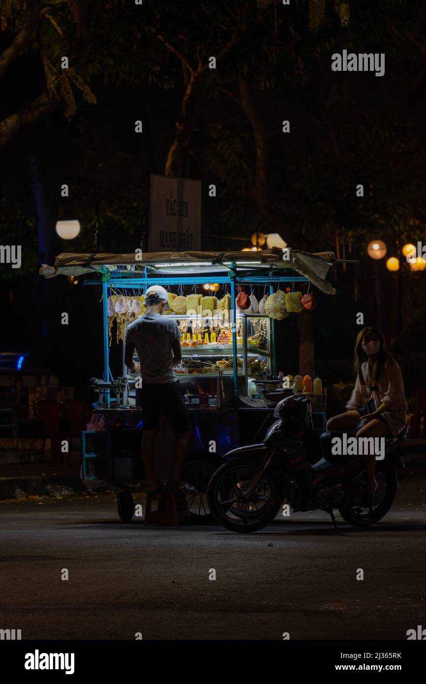 Traditional walking business selling dry squid on the street at night ...