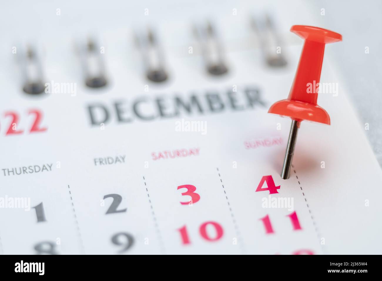 Red push pin on calendar 4th day of the month, mark the Event day with ...