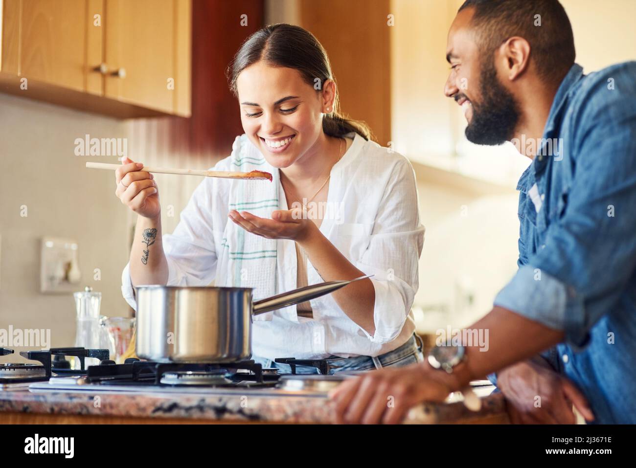 Lets see how good your cooking is. Shot of a couple cooking together at ...