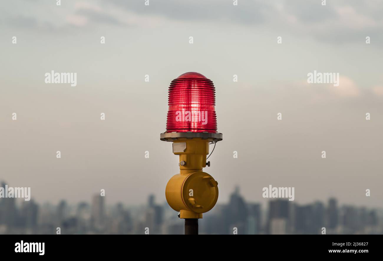 Red lantern of obstruction lights mounted on the rooftop of high rise ...