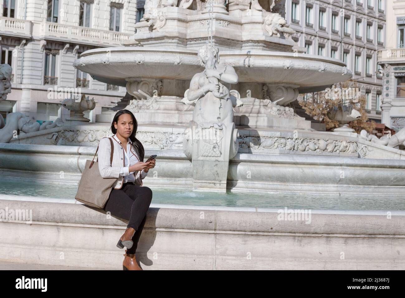 A young multiracial woman in the square of Jacobins in the city of Lyon ...