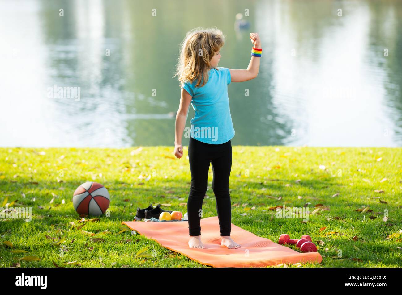 Sport children. Child with strong biceps muscles. Sport exercise for kids. Sporty children ...