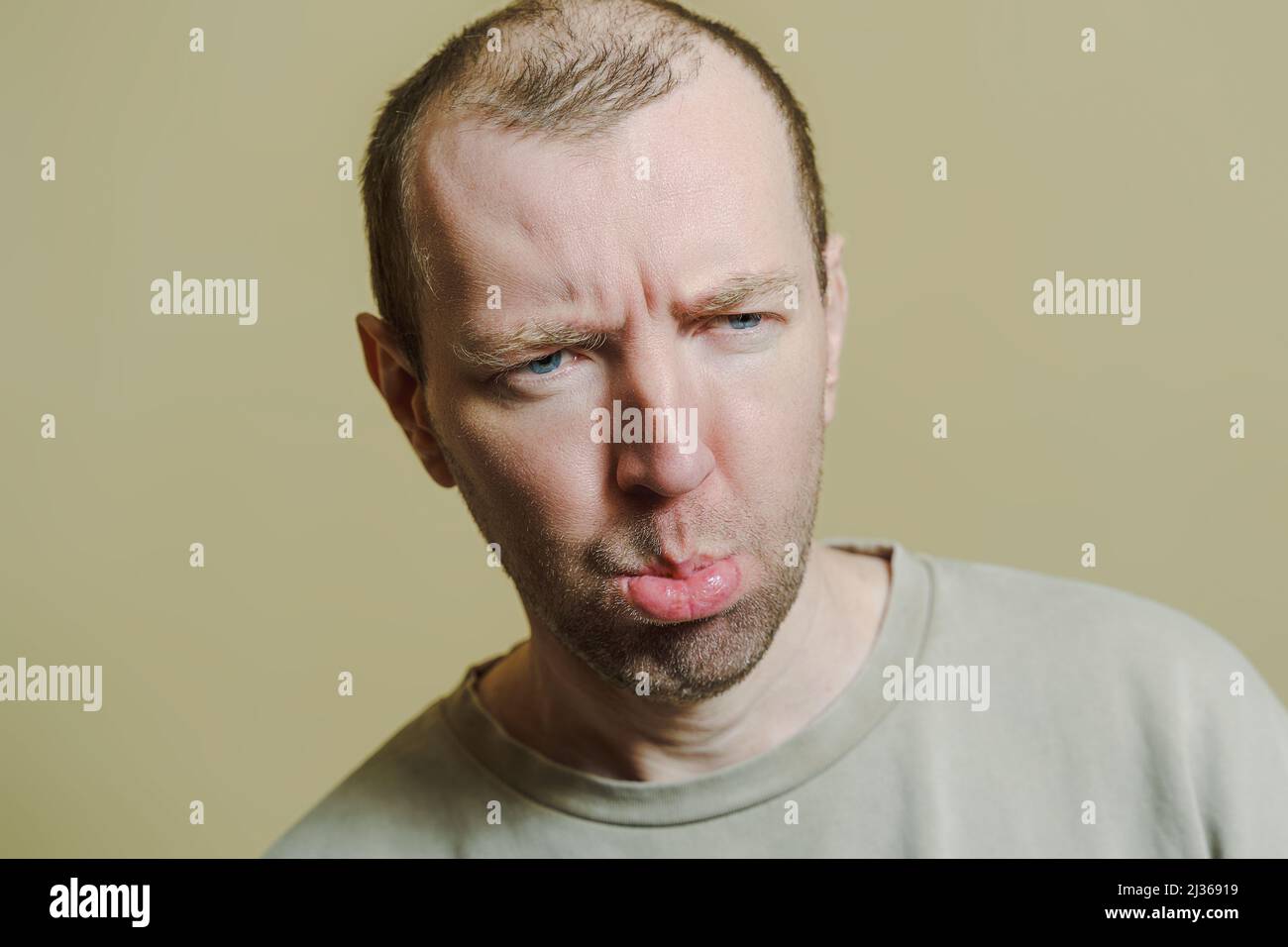 The man was offended. Portrait of a young man making faces Stock Photo ...