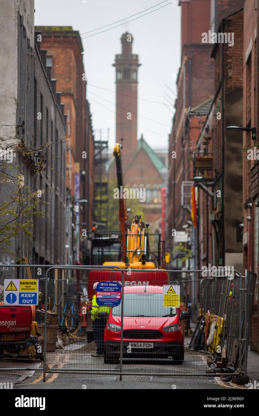 The water company United Utilities working in a narrow alleyway between ...