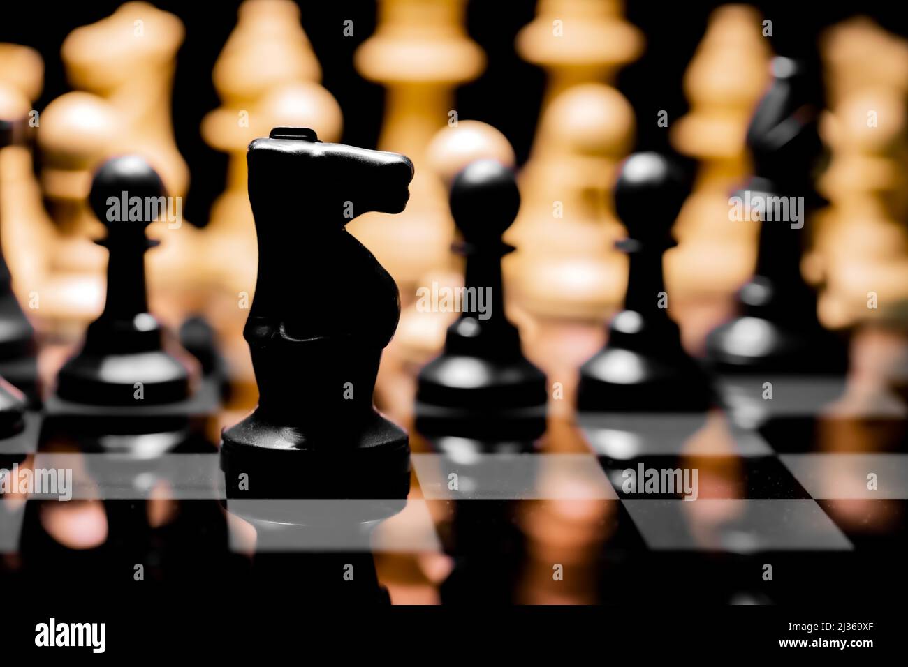 Close up of Chess pieces on a reflective mirror board surface with a ...