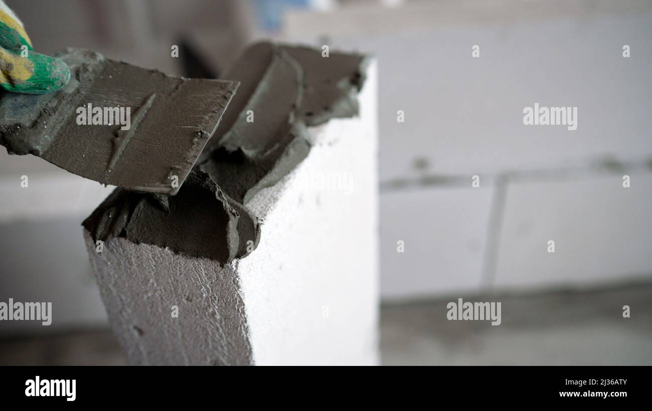 The process of applying a solution-glue to aerated concrete block. The ...