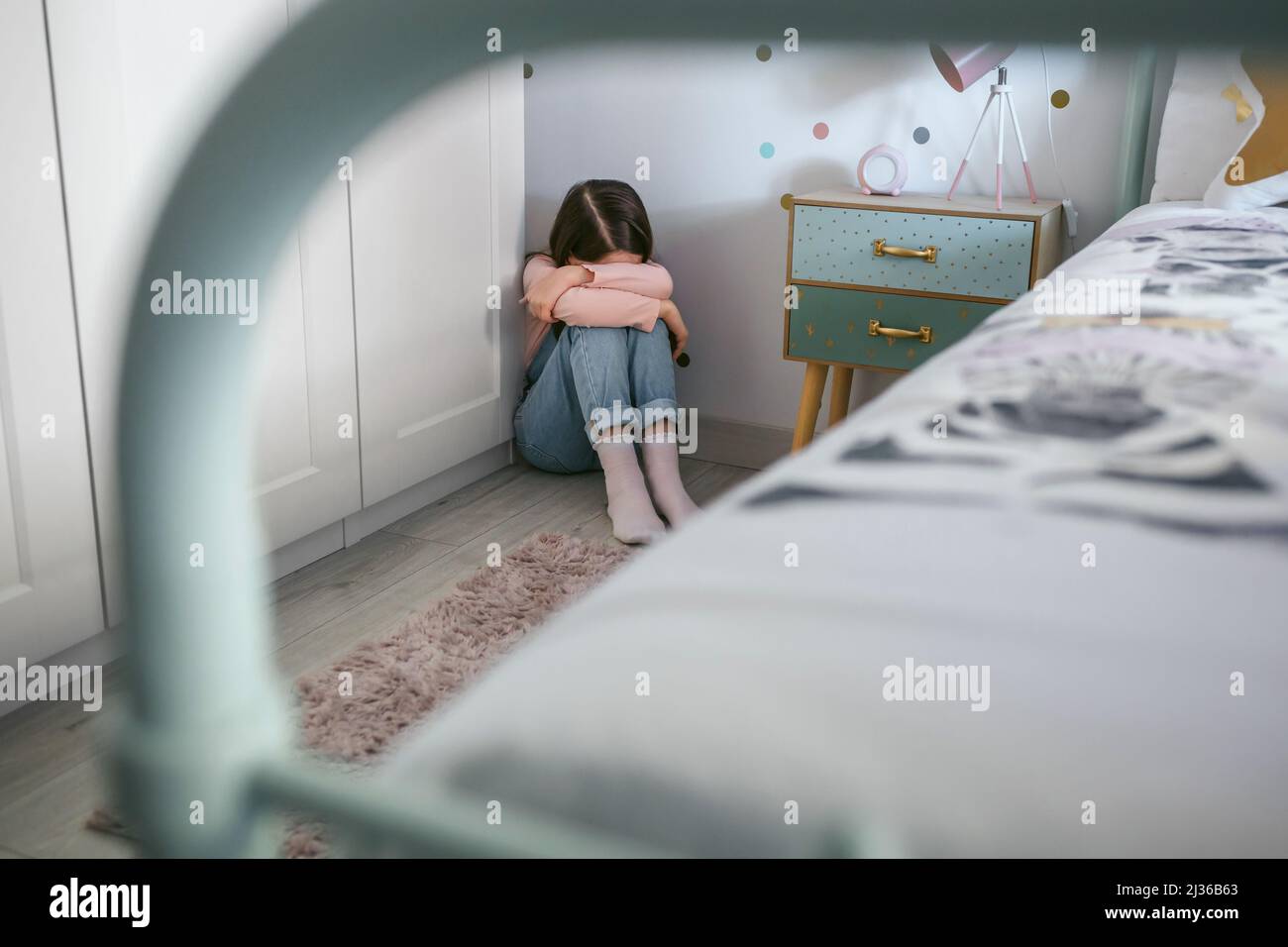 Unrecognizable girl crying on the floor in her bedroom Stock Photo - Alamy