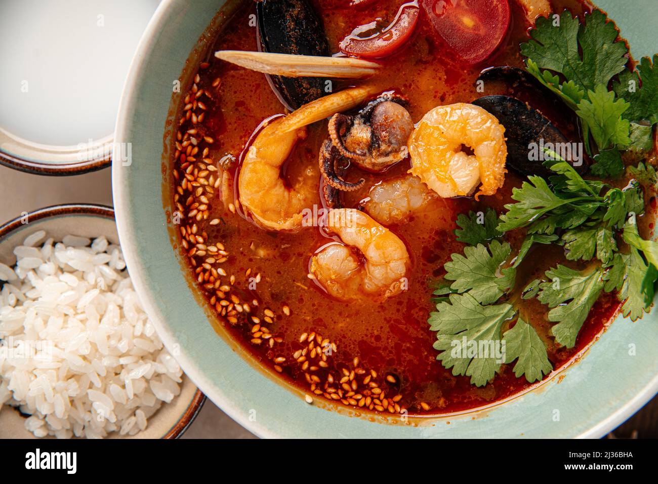 Bowl of thai seafood tom yam soup with rice Stock Photo - Alamy