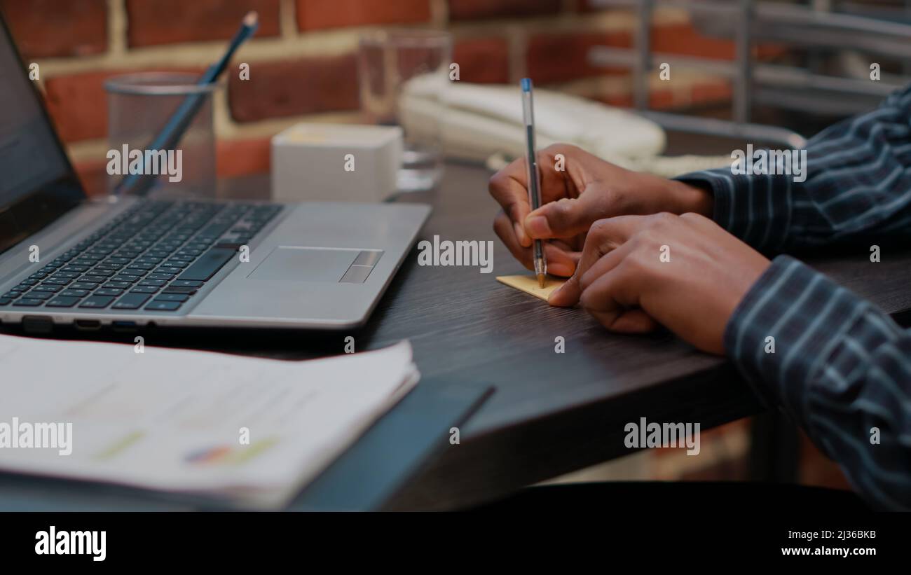 Business man putting adhesive post it paper on laptop display to ...