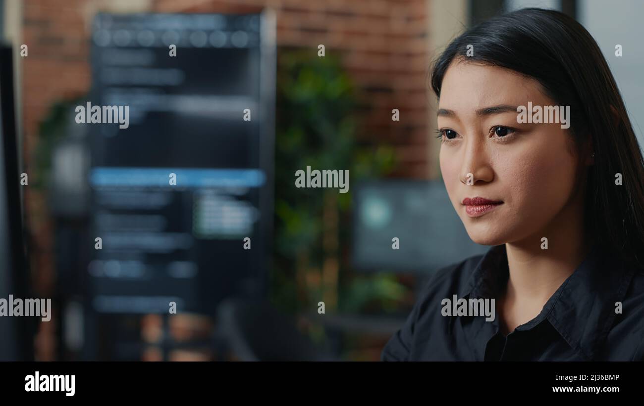 Focused asian software developer writing programming code and smiling ... Focused asian software developer writing programming code and smiling ...